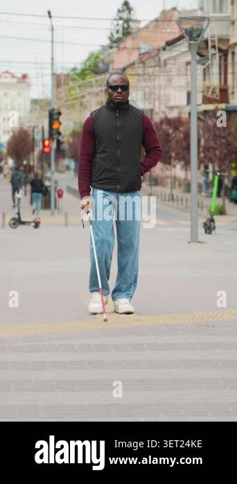 Confident man with a visual impairment walking along a tactile path on ...