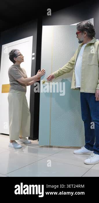 Mature husband and wife discussing a new door purchase for their home ...