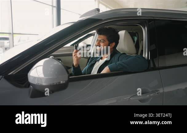 Joyful indian man sitting in his newly purchased automobile, smiling ...