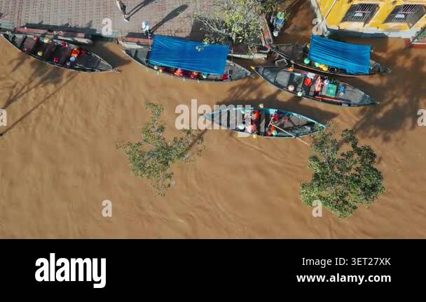 rescue team on boat in flooded city or town with buildings submerged in ...