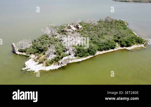 Drone slowly orbiting a small, uninhabited island with ancient ruins ...