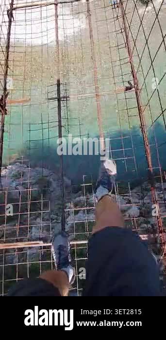 Point of view of a person carefully walking on a rusty and perilous ...