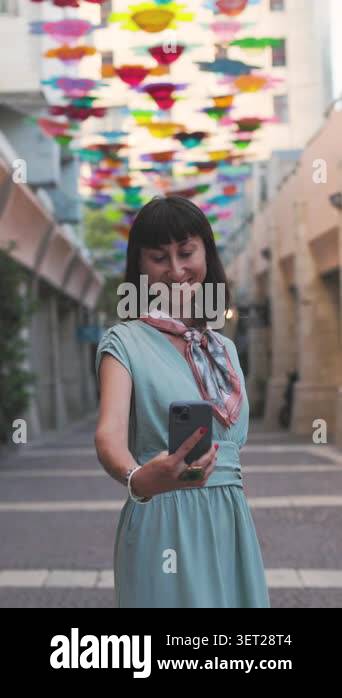 A woman walking through the streets of Jerusalems Old City, holding a ...