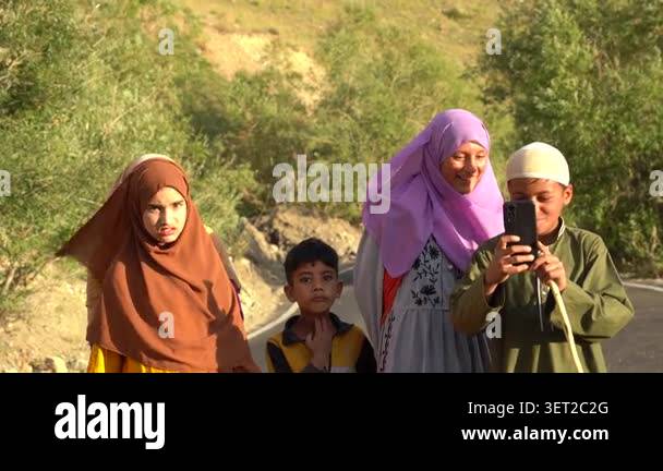 Ladakh, India, August 03, 2024 : Ladakhi children play with camera at ...