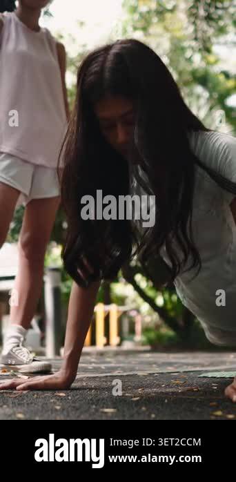 Young athletic thai woman doing push up exercises during a personal ...