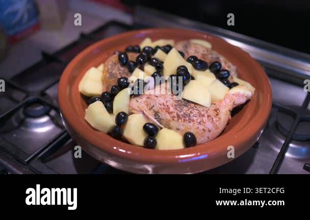 Close up view of covering a traditional moroccan tagine with raw ...
