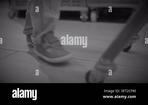 Low-angle close-up showing a young childs feet and lower legs in Velcro ...