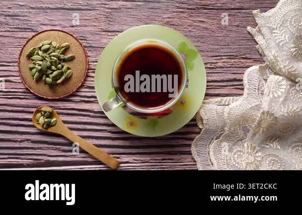A person brews tea with cardamom on a wooden table Stock Video Footage ...