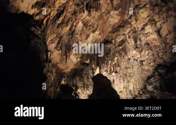 Exploring cave formations with stalactites and stalagmites, camera ...