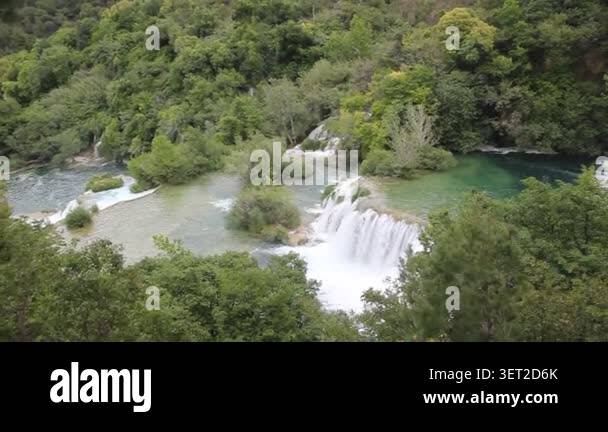 Beautiful cascading waterfalls flow through lush green forest and ...