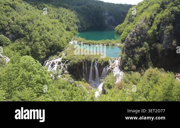 Beautiful cascading waterfalls flow into turquoise lakes surrounded by ...