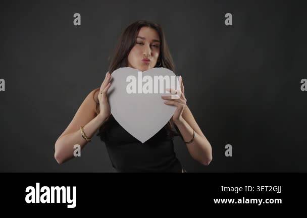 Love and affection concept, young woman holding white heart shape ...