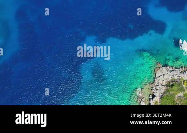 Scenic view of Agios Nikolaos port in Zakynthos with crystal blue water ...