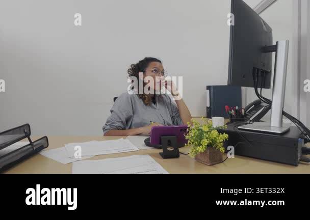 Overwhelmed young female employee feeling stressed and anxious while ...