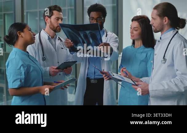 Team five multiethnic doctors talking analyzing patient lung x-ray ...