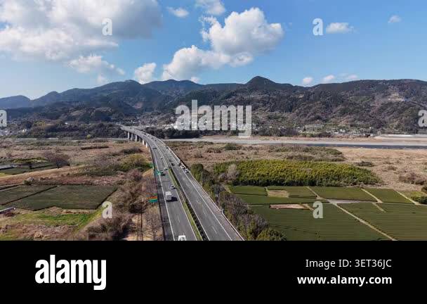 An aerial view of a river, bridges and the surrounding mountains and ...