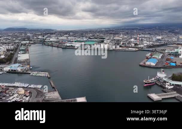 An aerial view of a coastal industrial town, harbour and breakwaters by ...