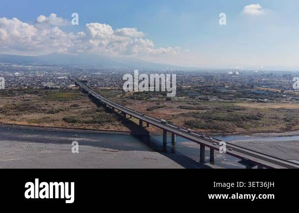 An aerial view of a river, bridges and the surrounding mountains and ...