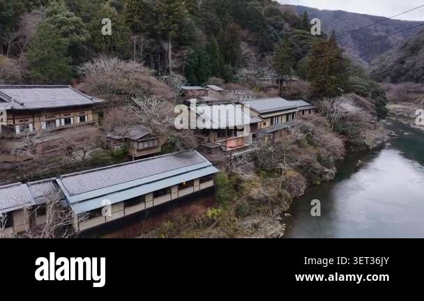 An aerial view of the forested river valley near Arashiyama with a ...