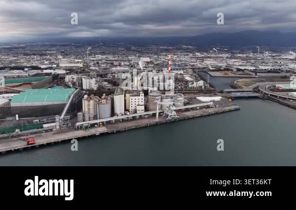 An aerial view of a coastal industrial town, harbour and breakwaters by ...