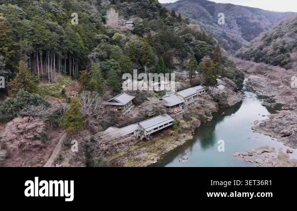An aerial view of the forested river valley near Arashiyama with a ...