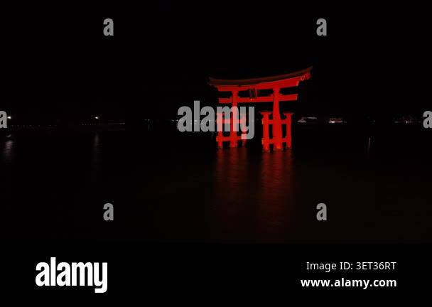 The iconic red floating torii gate of Itsukushima Shrine illuminated at ...