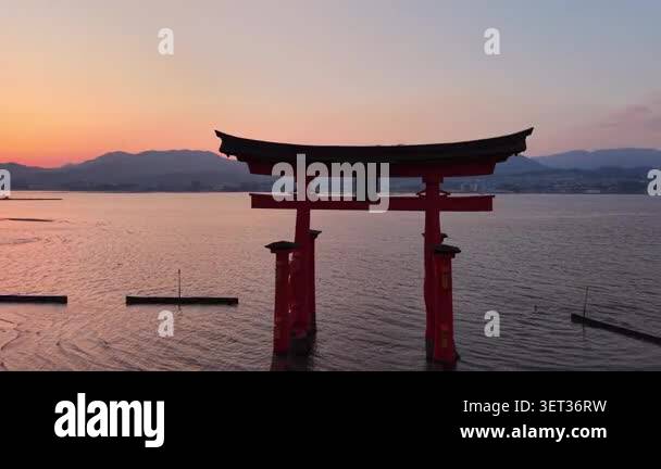 The iconic red floating torii gate of Itsukushima Shrine illuminated at ...