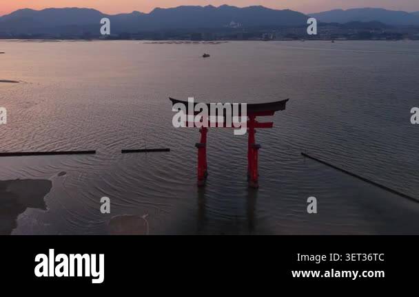 The iconic red floating torii gate of Itsukushima Shrine illuminated at ...