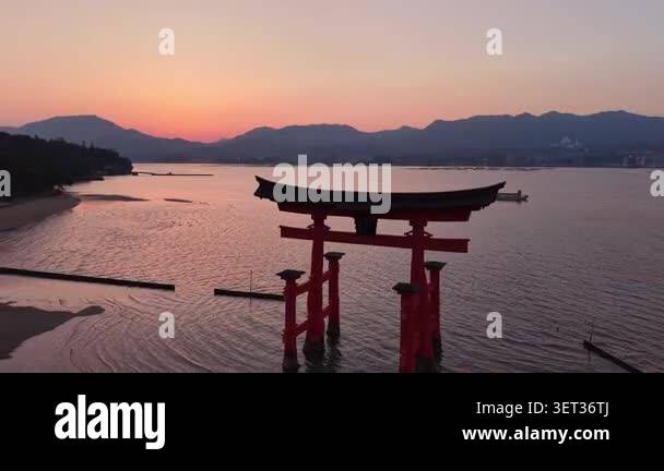 The iconic red floating torii gate of Itsukushima Shrine illuminated at ...