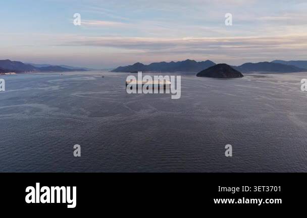 An aerial view of a large cargo ship sailing the Seto Inland Sea at ...