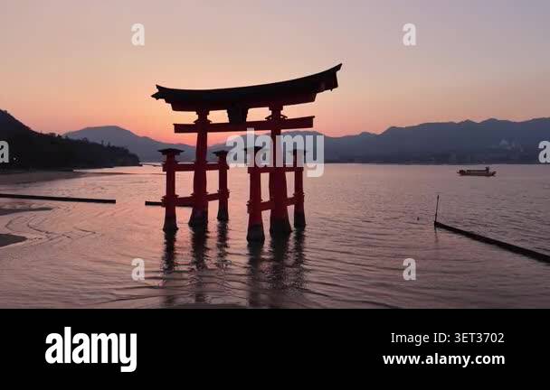 The iconic red floating torii gate of Itsukushima Shrine illuminated at ...
