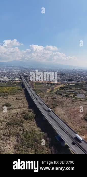 An aerial view of a river, bridges and the surrounding mountains and ...