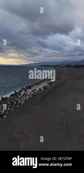 An aerial view of a coastal industrial town, harbour and breakwaters by ...
