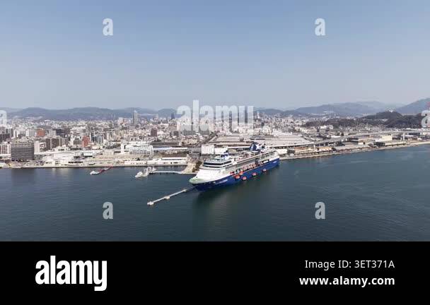 An aerial view of a large cruise liner docked in the harbour by the ...