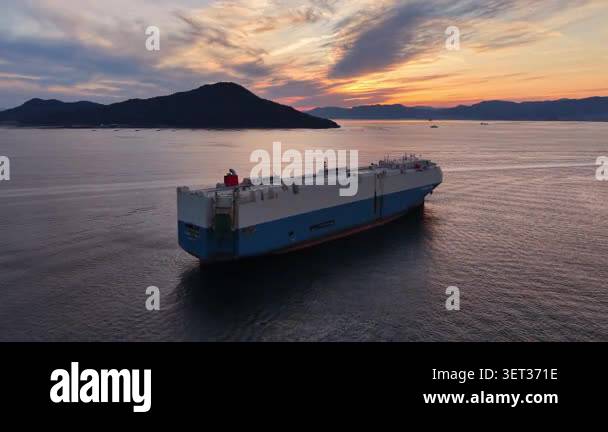 An aerial view of a large cargo ship sailing the Seto Inland Sea at ...