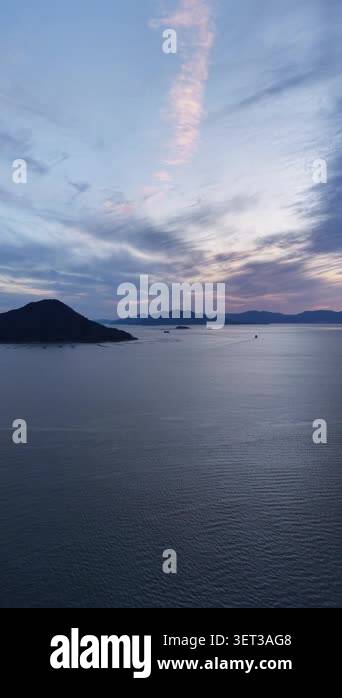 An aerial view of a large cargo ship sailing the Seto Inland Sea at ...