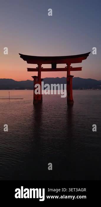 The iconic red floating torii gate of Itsukushima Shrine illuminated at ...