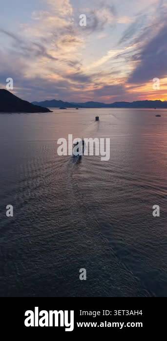An aerial view of a large cargo ship sailing the Seto Inland Sea at ...