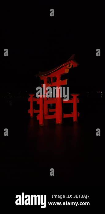 The iconic red floating torii gate of Itsukushima Shrine illuminated at ...