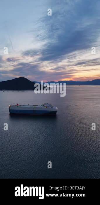 An aerial view of a large cargo ship sailing the Seto Inland Sea at ...
