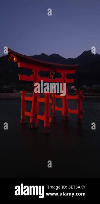 The iconic red floating torii gate of Itsukushima Shrine illuminated at ...