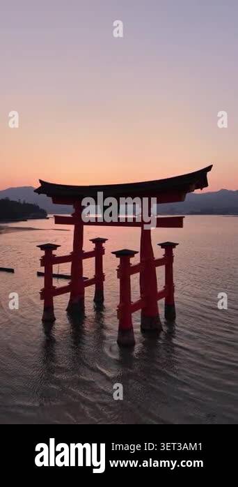 The iconic red floating torii gate of Itsukushima Shrine illuminated at ...