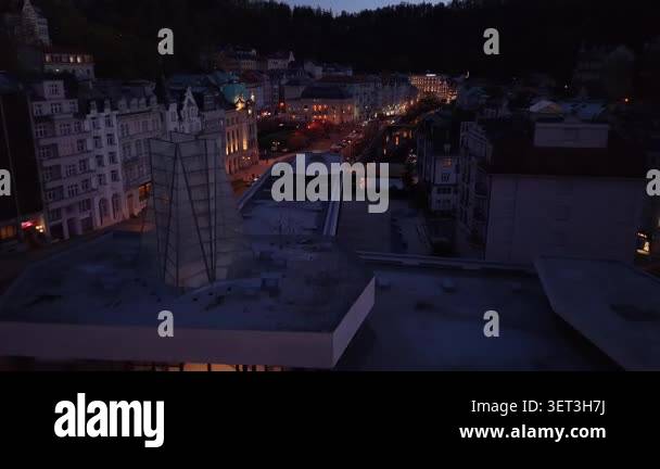 An aerial view of the spa town of Karlovy Vary illuminated at dusk and ...