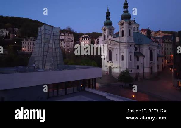 An aerial view of the spa town of Karlovy Vary illuminated at dusk and ...