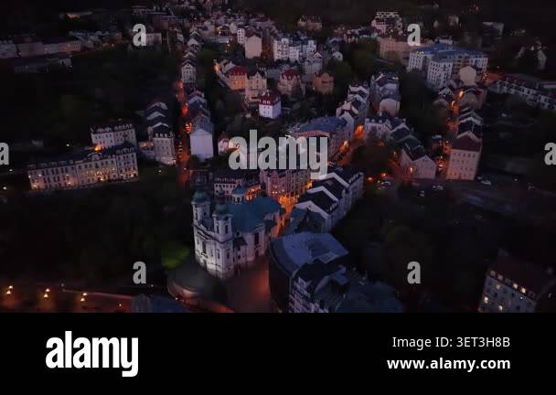 An aerial view of the spa town of Karlovy Vary illuminated at dusk and ...
