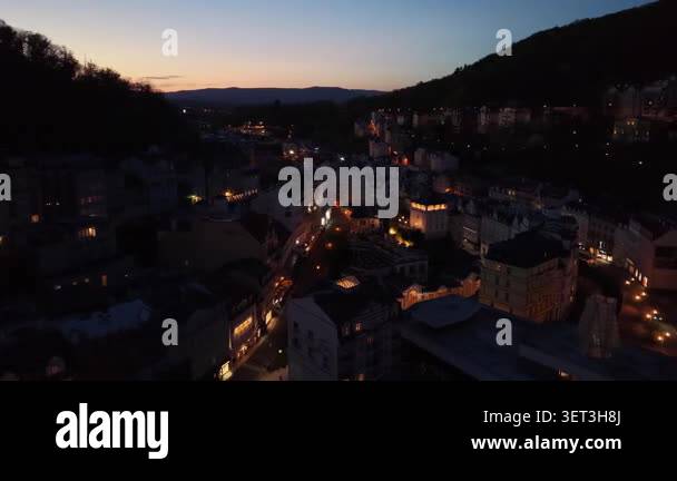 An aerial view of the spa town of Karlovy Vary illuminated at dusk and ...