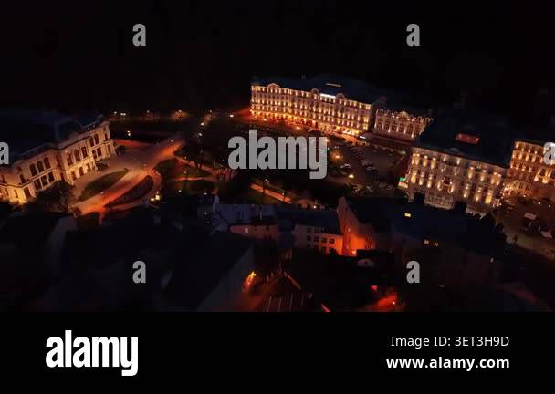 An aerial view of the spa town of Karlovy Vary illuminated at dusk and ...
