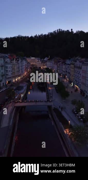 An aerial view of the spa town of Karlovy Vary illuminated at dusk and ...
