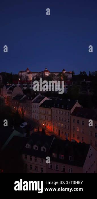 An aerial view of the spa town of Karlovy Vary illuminated at dusk and ...