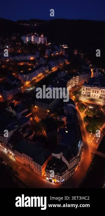 An aerial view of the spa town of Karlovy Vary illuminated at dusk and ...
